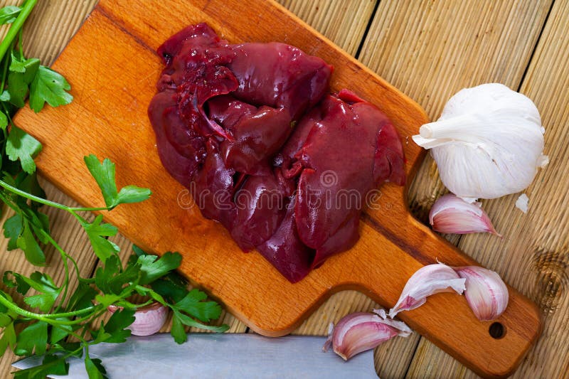 Raw Rabbit Liver with Spices and Parsley on the Kitchen Table. View ...