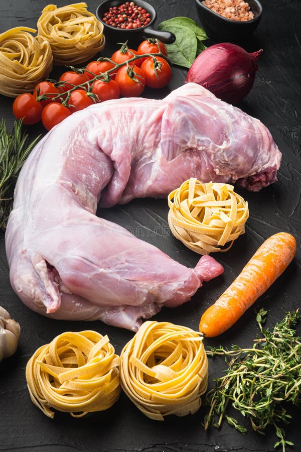 Raw Rabbit Meat with Fresh Vegetables Ready for Cooking, on Black Stone ...