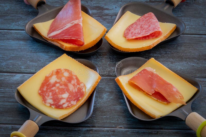 Raw Raclette Cheese in a Skillet with Charcuterie Stock Image - Image ...
