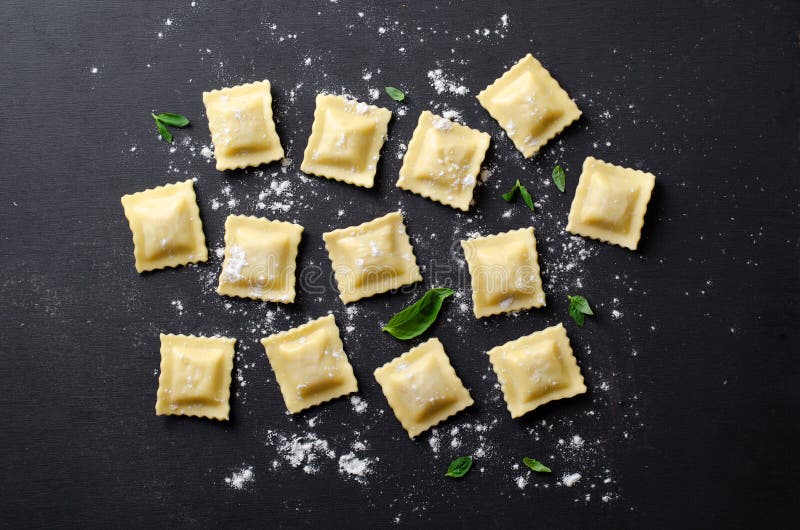 Raw Ravioli with Flour and Basil on Dark Background Stock Image - Image ...