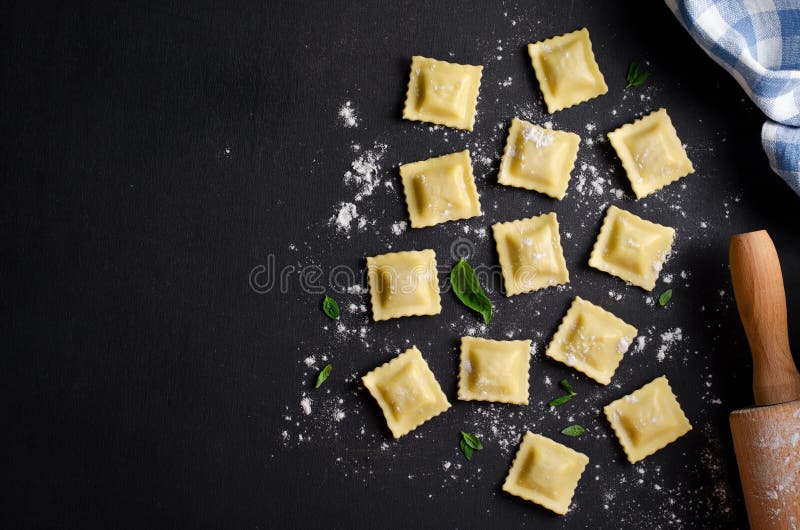 Raw Ravioli with Flour and Basil on Dark Background Stock Photo - Image ...