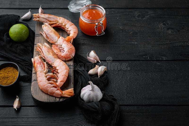 Raw Red Argentinian Prawns, on Wooden Cutting Board, on Black Wooden ...