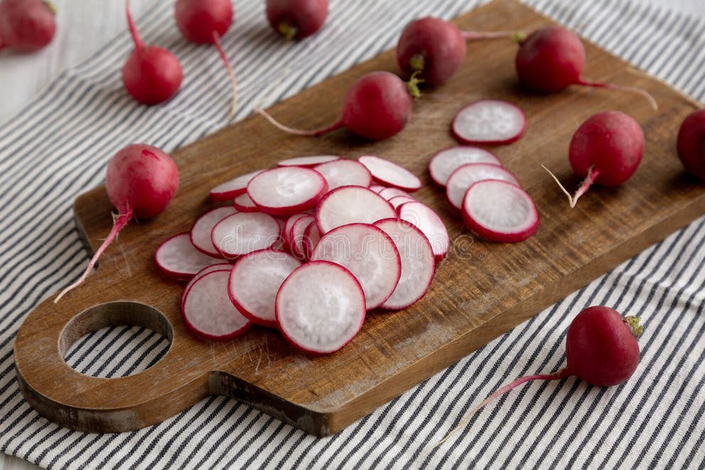 Raw Red Radish Slices on a Cutting Board, Side View Stock Photo - Image ...