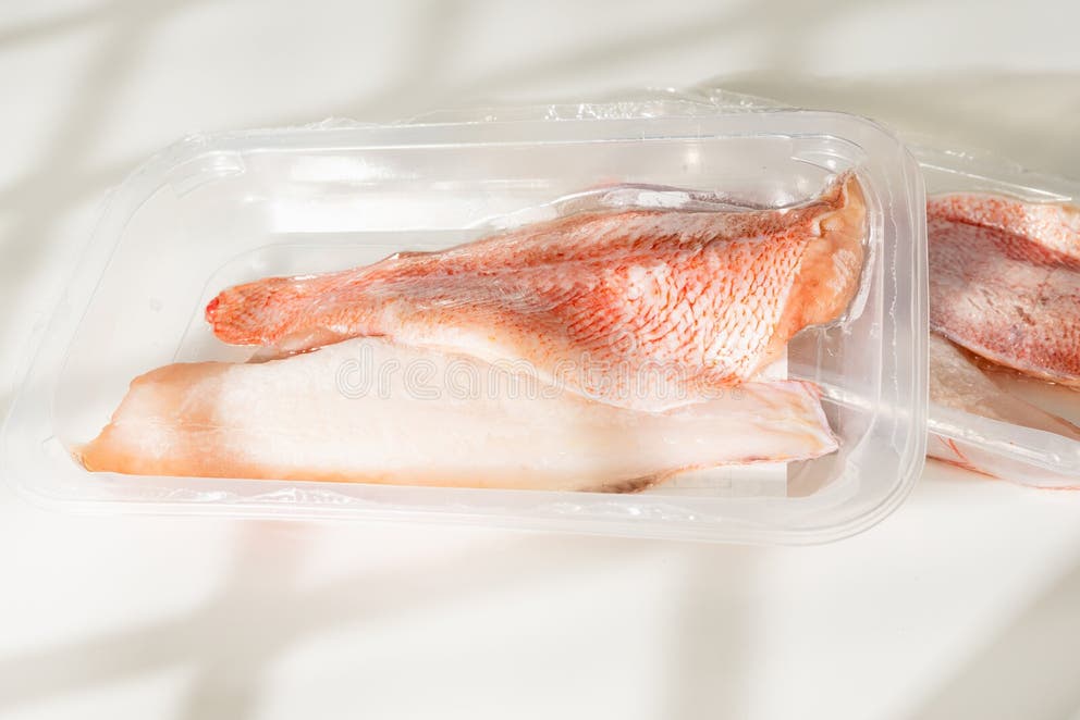 Fresh Red Snapper Fillets in a Clear Plastic Container on a White ...