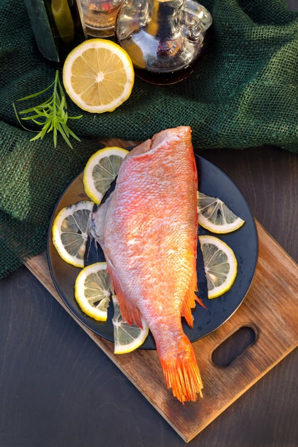 Raw Red Snapper on a Plate with Lemon Stock Image - Image of olive ...