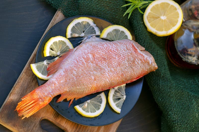 Raw Red Snapper on a Plate with Lemon Stock Image - Image of rosemary ...