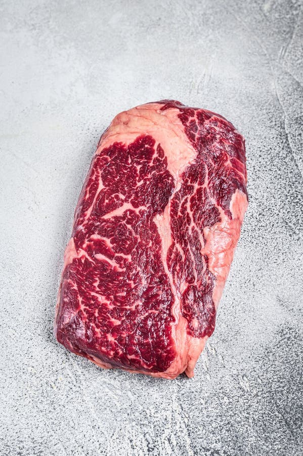 Raw Rib Eye Beef Meat Steak on a Table Prepared for the Gril. White ...