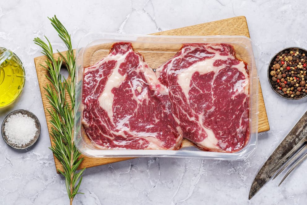 Raw Ribeye Steaks with Savory Spices Stock Photo - Image of spice ...