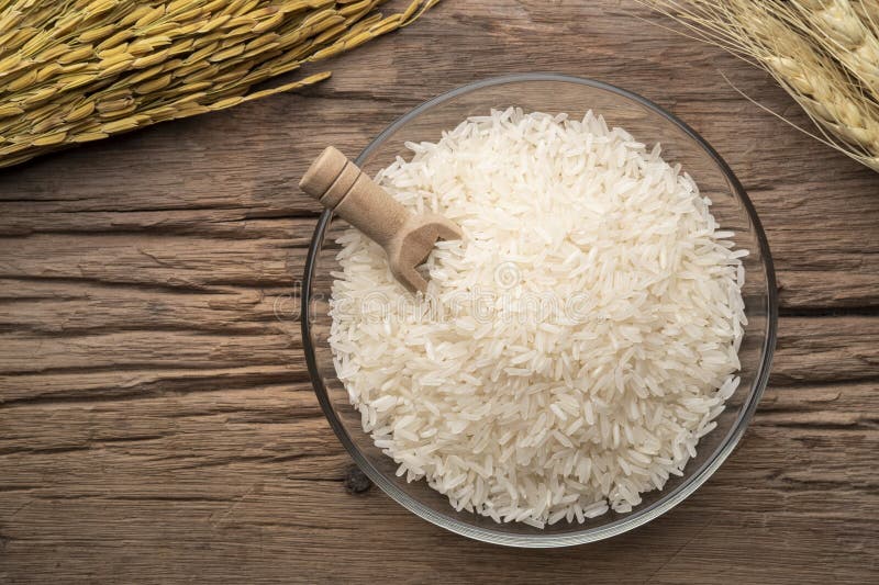 Raw Rice in a Glass Plate on Wooden Table.Uncooked Rice Stock Image ...