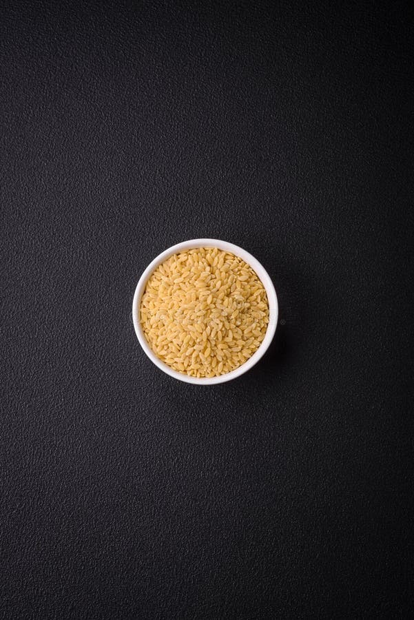 Raw Risoni Pasta Made from Durum Wheat on a Dark Concrete Background ...