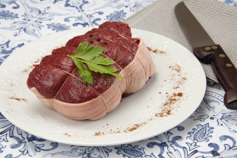Raw roast beef on a plate stock image. Image of spice - 231506321