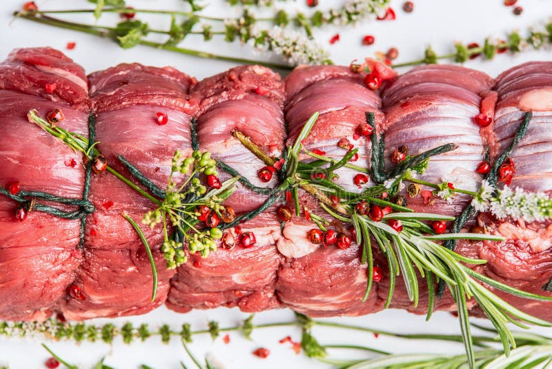 Raw Roast Beef with Herbs Tied with a Rope with Cooking Ingredients ...