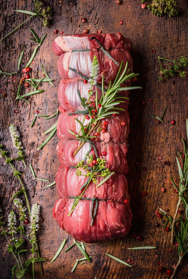 Raw Roast Beef with Herbs and Spices Tied with a Rope on Wooden ...