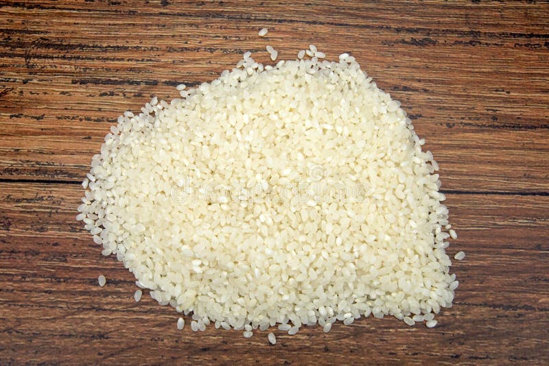 Raw round rice on a table stock photo. Image of white - 206989808