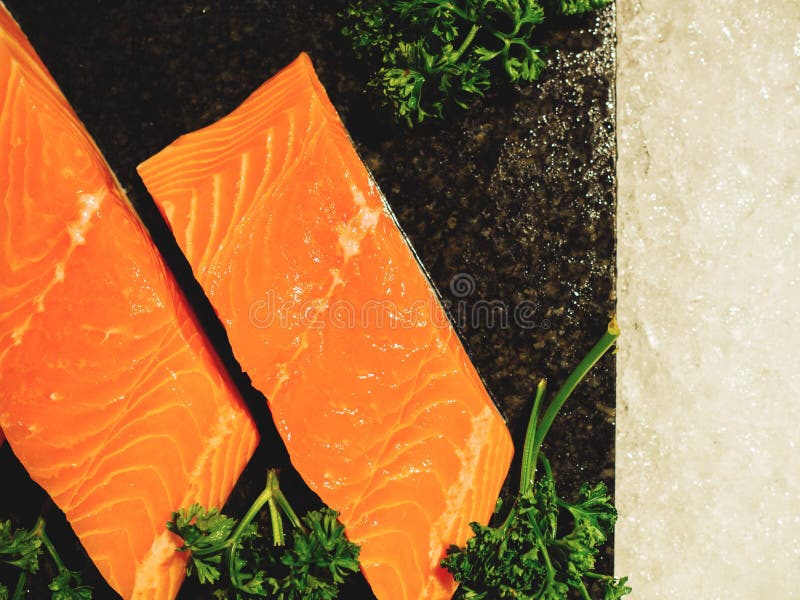 Raw Salmon Filet on Black Marble and Ice Background Stock Image - Image ...