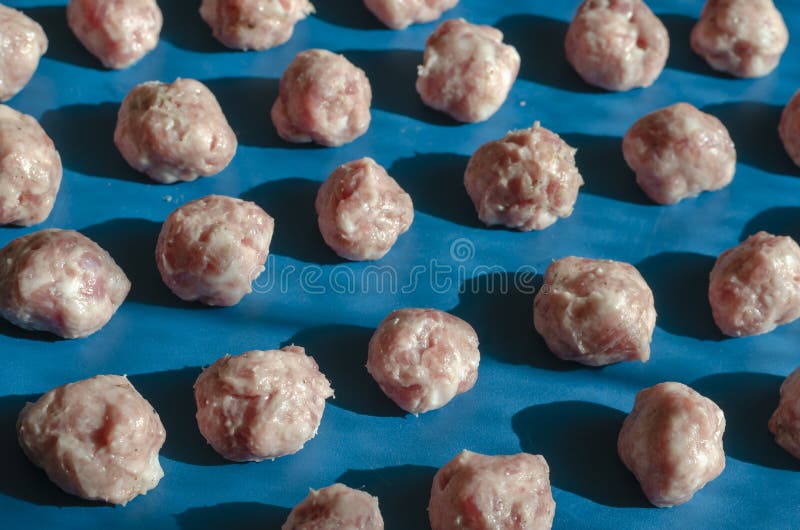 Raw Shaped Meatballs in Sunbeams on Blue Stock Photo - Image of ...