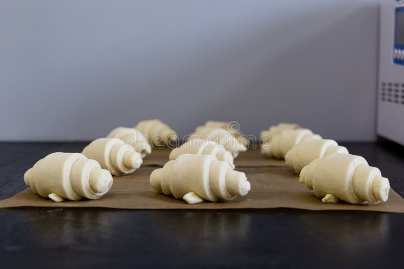 Raw Shaped and Rolled-in Croissants Lie in Rows on the Baking Sheet ...