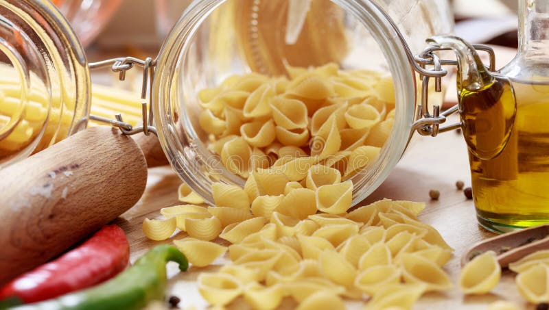 Raw Shells Pasta, Chilli Peppers and Olive Oil Stock Photo - Image of ...