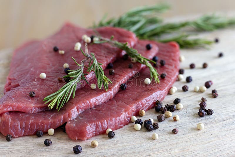 Raw Slices of Lean Beef with Pepper and Rosemary Stock Image - Image of ...