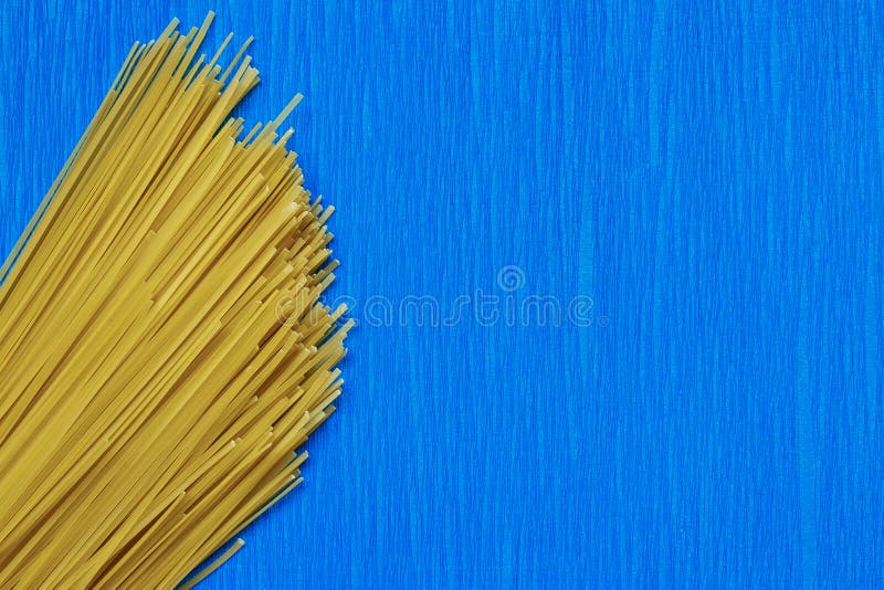 Raw Spaghetti Pasta on Blue Background. Stock Image - Image of cereals ...
