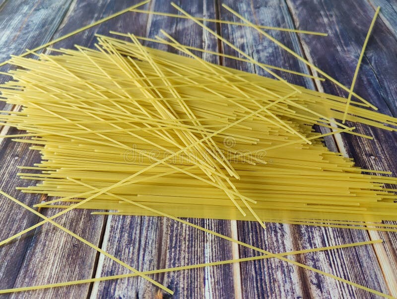 Raw Spaghetti on a Wooden Table. Main Ingredient for Italian Pasta ...