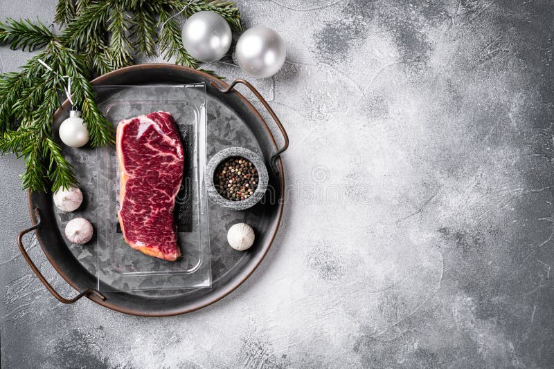 Raw Steak with Christmas Tree Decorations, on Gray Stone Table ...