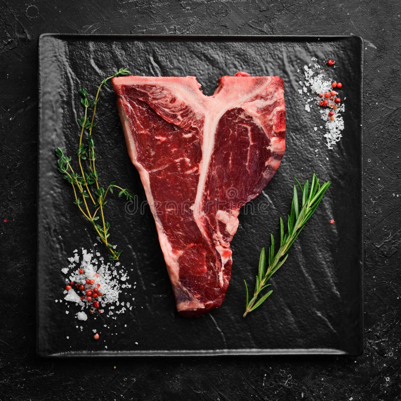 Raw T-bone Steak on a Stone Table with Thyme, Rosemary and Spices. Flat ...