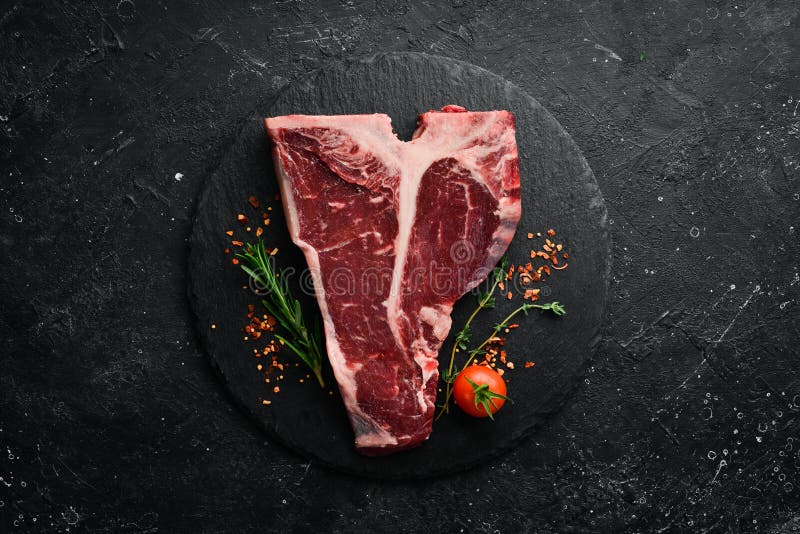 Raw T-bone Steak on a Stone Table with Thyme, Rosemary and Spices. Flat ...