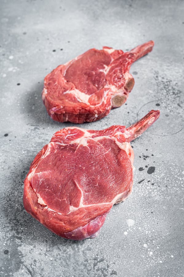 Raw Tomahawk Beef (veal) Steak on Butcher Table. Gray Background Stock ...