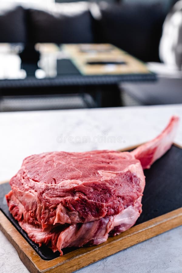 Raw tomahawk steak on tray stock photo. Image of fresh - 277498362