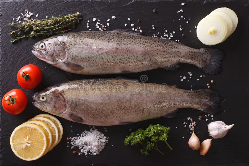 Raw Trout with Ingredients on a Slate Board Closeup. Horizontal Stock ...