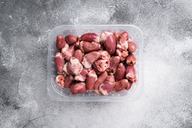 Raw Turkey Hearts in Plastic Pack, on Gray Stone Table Background, Top ...