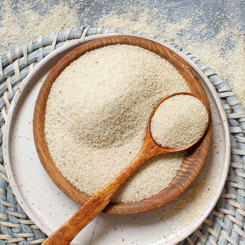 Raw Uncooked Fonio Seeds with a Spoon on a Plate on Grey Background ...