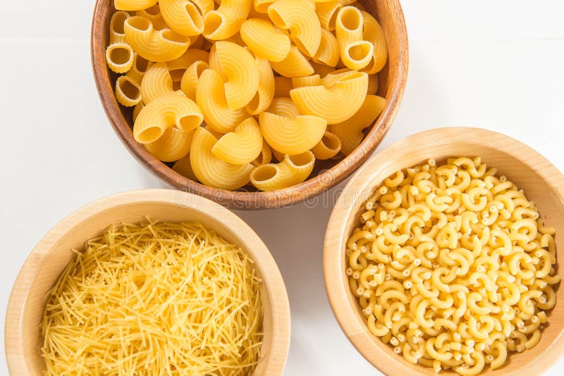Raw uncooked pasta in bowl stock photo. Image of meal - 65261482