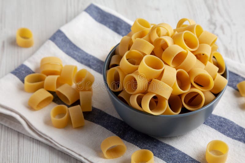 Raw Uncooked Pasta Calamarata in a Bowl, Side View Stock Image - Image ...