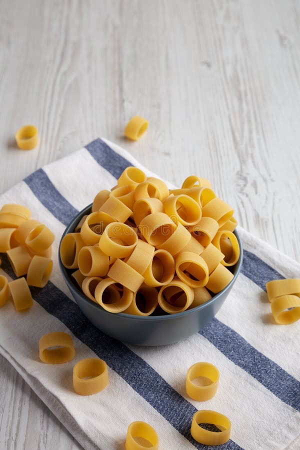 Raw Uncooked Pasta Calamarata in a Bowl, Side View. Copy Space Stock ...