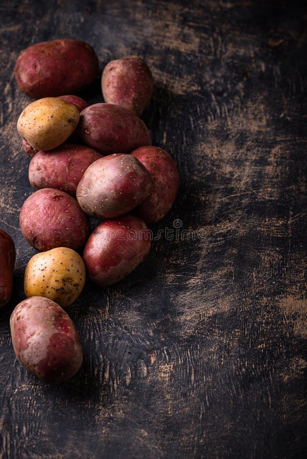 Raw Uncooked Potato on Dark Table Stock Image - Image of root ...