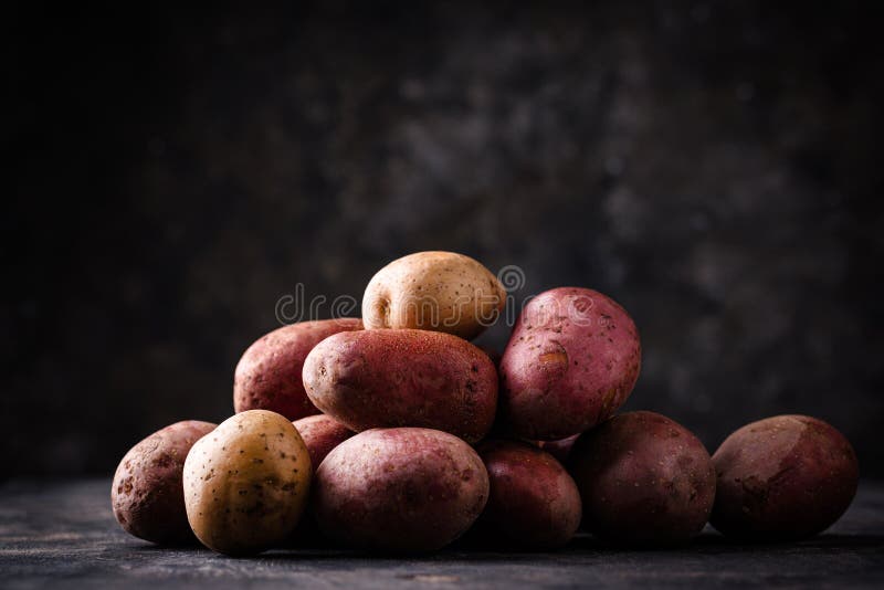 Raw Uncooked Potato on Dark Table Stock Image - Image of rustic ...