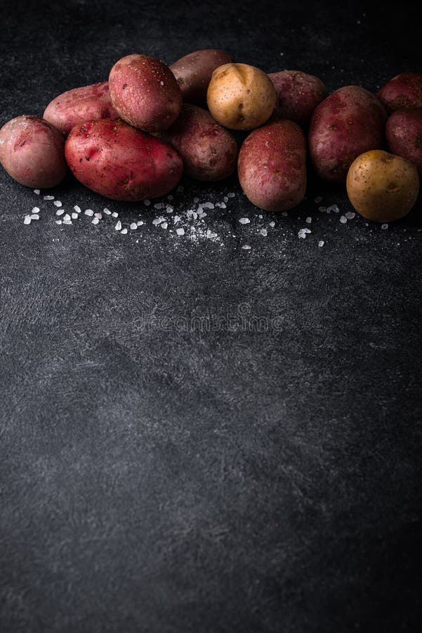 Raw Uncooked Potato on Dark Table Stock Photo - Image of ingredient ...