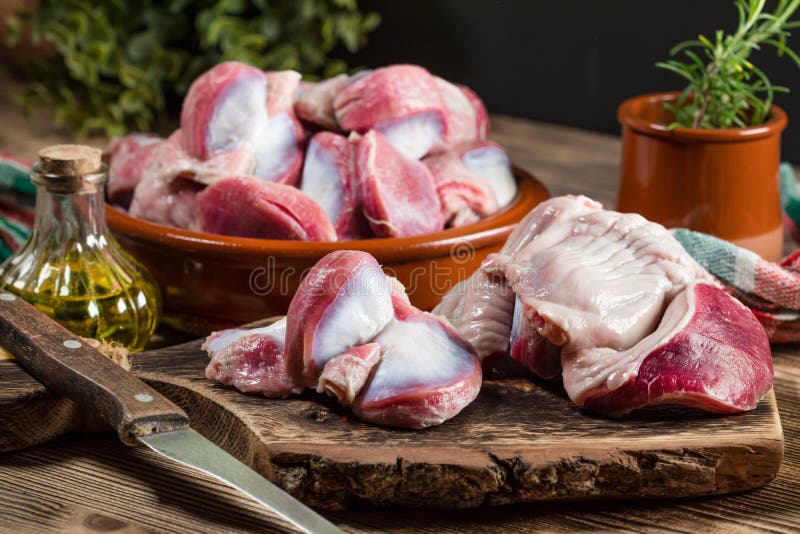Uncooked Raw Turkey Necks Meat on a Butcher Wooden Board with Cleaver ...