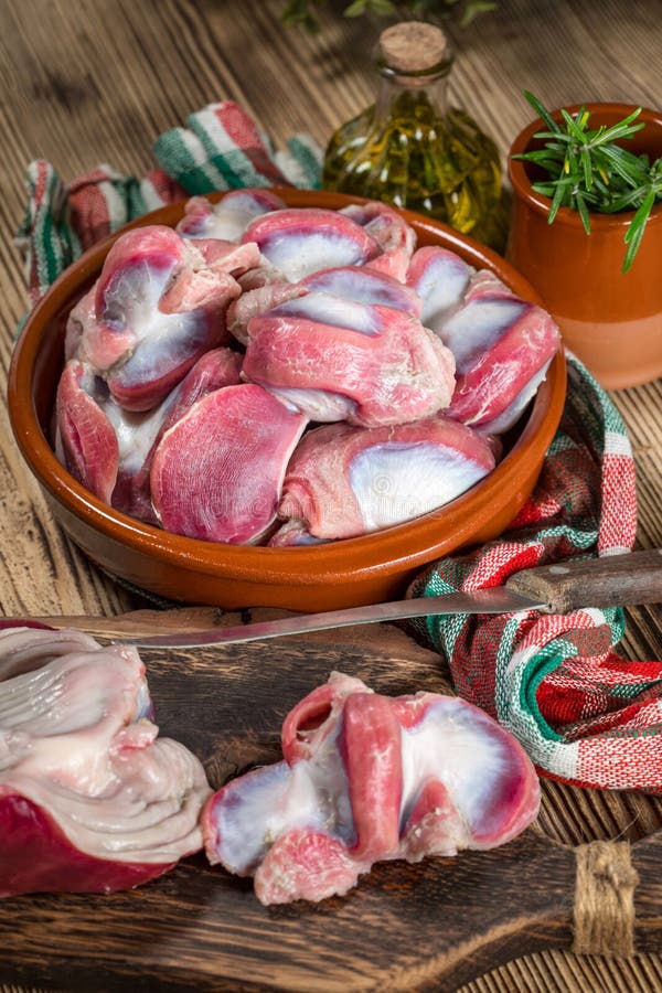 Uncooked Raw Turkey Necks Meat on a Butcher Wooden Board with Cleaver ...