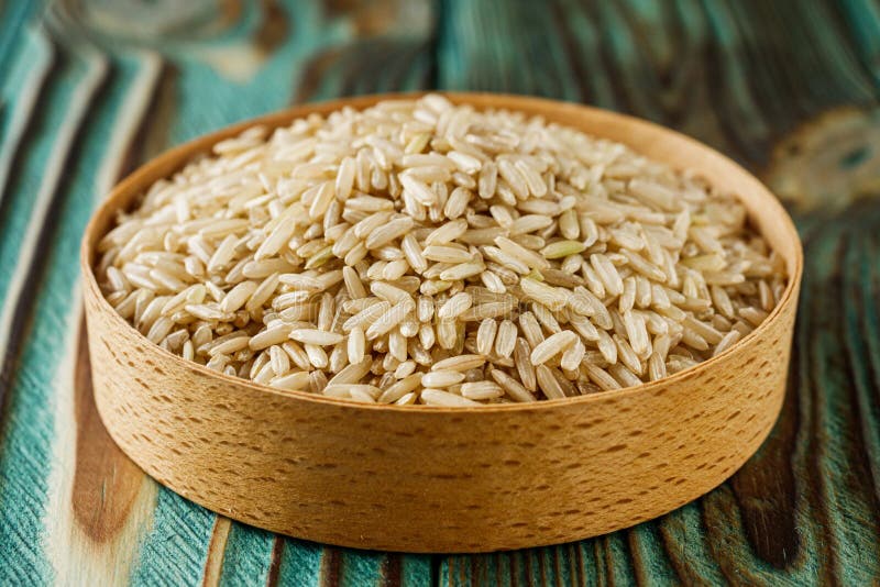 Raw Unpolished Rice on a Wooden Rustic Background Stock Image - Image ...
