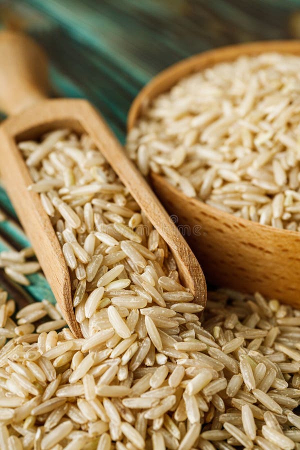 Raw Unpolished Rice on a Wooden Rustic Background Stock Photo - Image ...