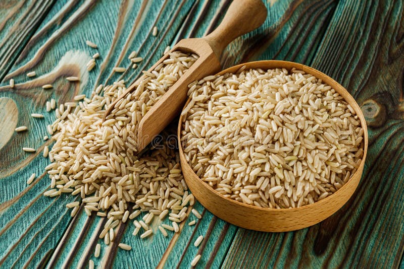 Raw Unpolished Rice on a Wooden Rustic Background Stock Image - Image ...