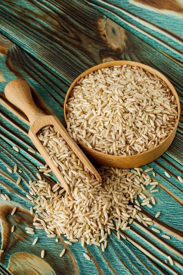 Raw Unpolished Rice on a Wooden Rustic Background Stock Image - Image ...