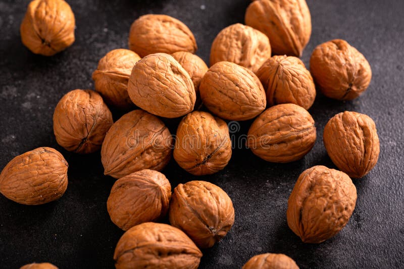 Raw Walnut in Shell on Old Rustic Background Stock Image - Image of ...