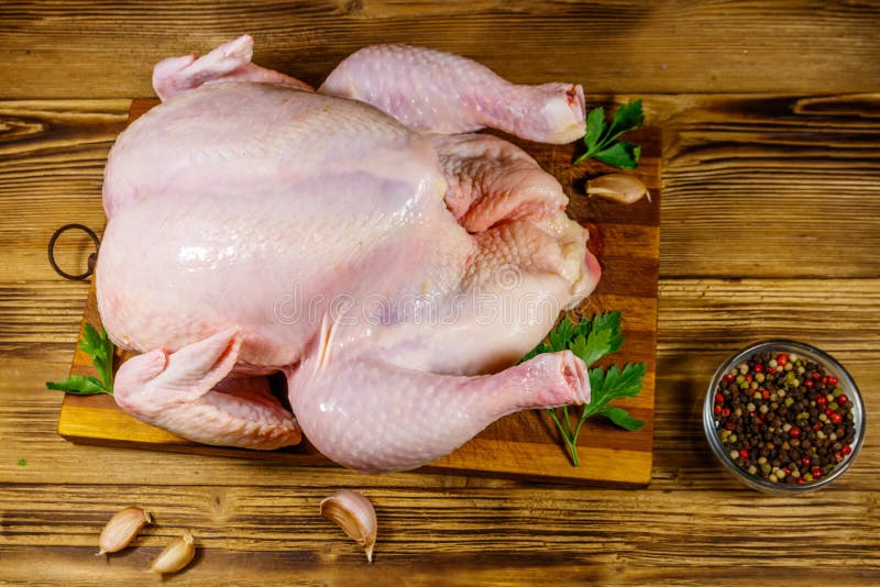 Raw Whole Chicken with Spices on Wooden Table. Top View Stock Photo ...