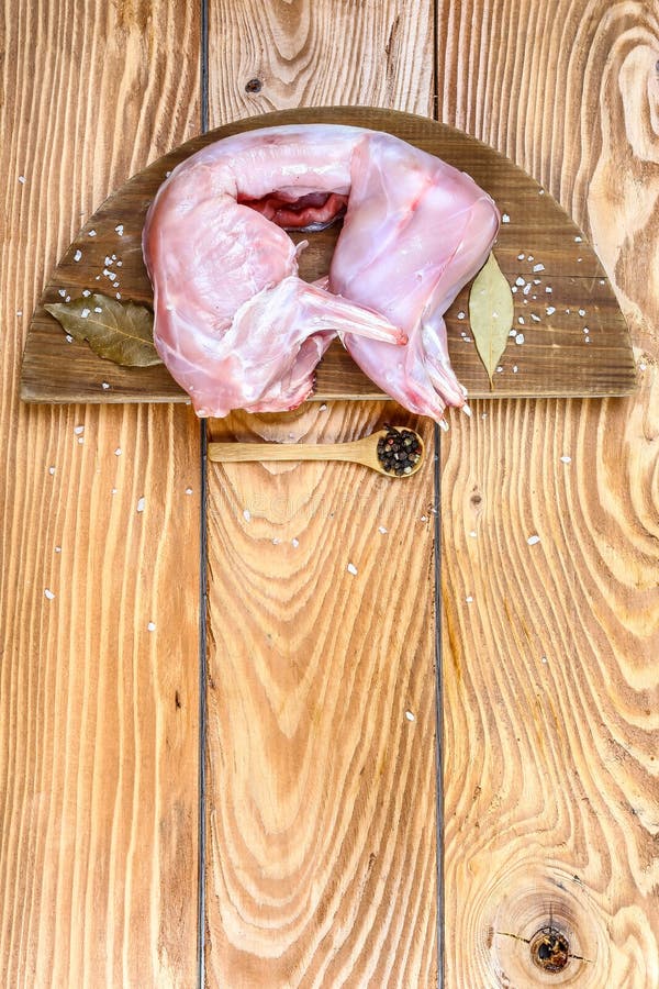 Raw Whole Rabbit with Spices on a Dark Rustic Background. Top View ...
