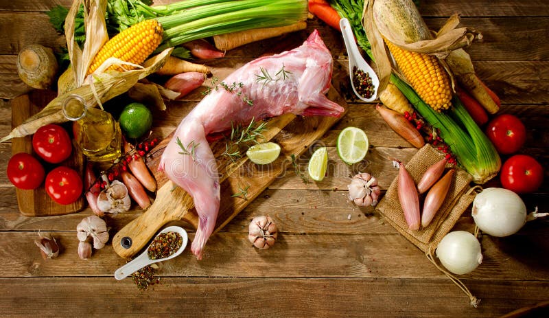 Raw Whole Rabbit with Vegetables and Spices on a Dark Rustic Ba Stock ...