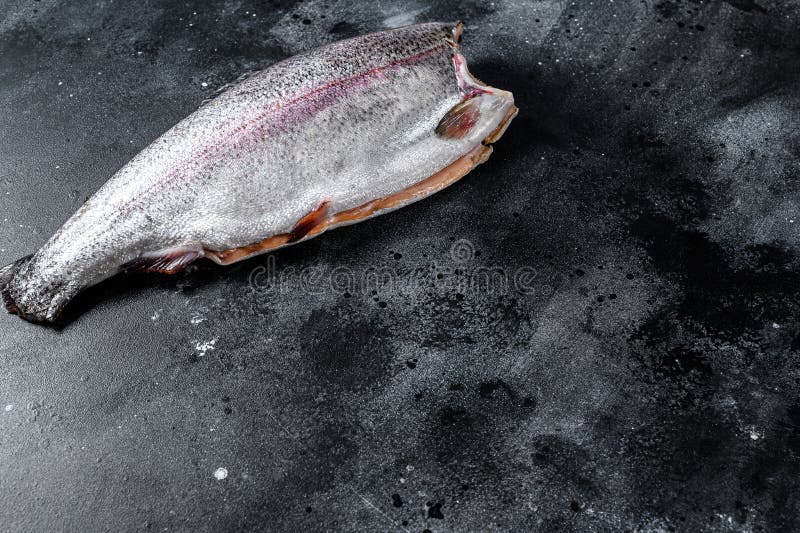 Raw Whole Trout Fish without a Head. Black Background. Top View Stock ...